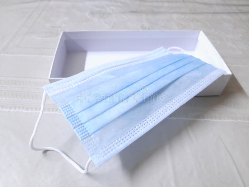 Surgical Mask on a White Box. Stock Photo - Image of furniture, paper ...