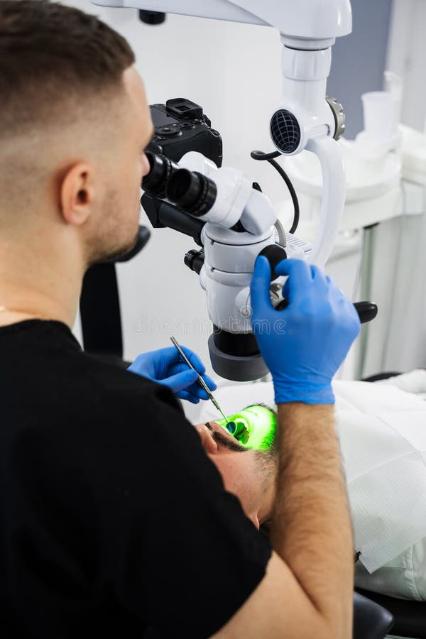 Surgical Microscope Examination Procedure. Dentist is Looking on Teeth ...