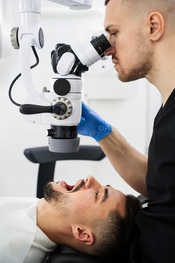 Surgical Microscope Examination Procedure. Dentist is Looking on Teeth ...