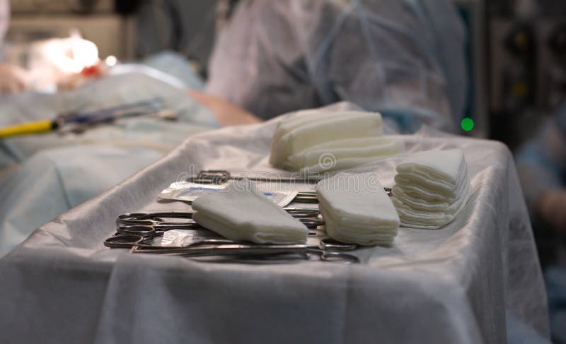 A Surgical Sterile Instrument Lies on a Tray in Front of the Operating ...