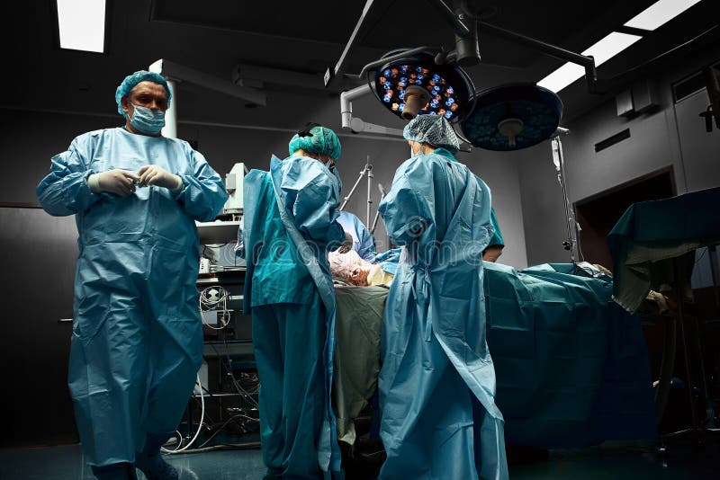 Surgical Team Operating on Patient in Theater in Hospital Stock Photo ...