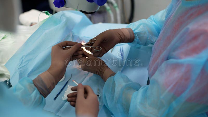 Surgical Team Performing Eye Surgery Using Medical Instruments. Stock ...