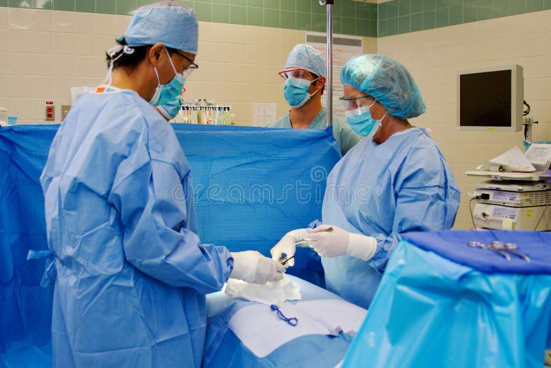 Surgical Team Performing Surgery Stock Photo - Image of hospital ...