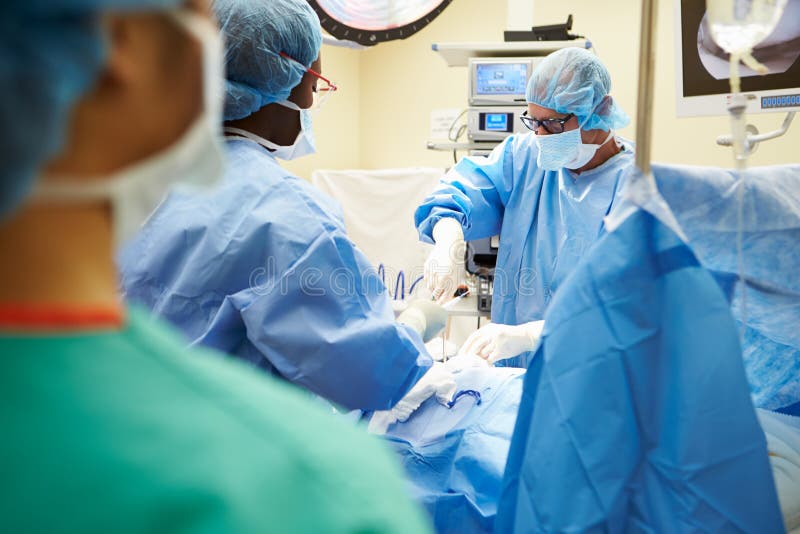 Surgical Team Working in Operating Theatre Stock Photo - Image of ...