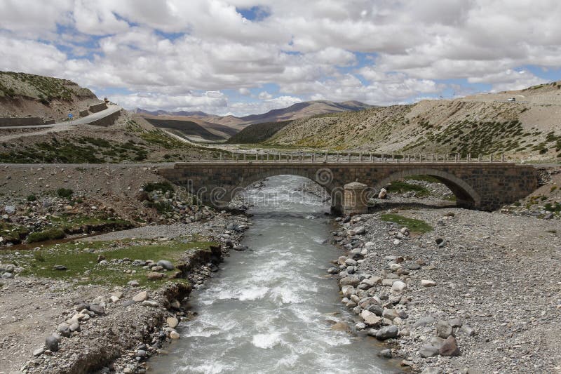 A Surging River Under the Bridge Stock Photo - Image of clouds, season ...