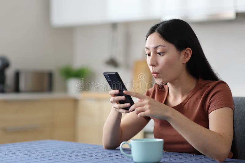 Surprised Asian Woman Using Smart Phone in a Kitchen Stock Image - Image of home, korean: 369238069