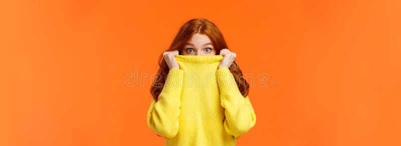 Surprised And Astonished Cute Curious Redhead Female Pulling Sweater