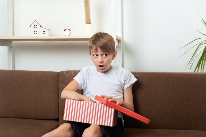 Surprised Boy Opens the Gift Box and Looks Around. Suddenness Stock ...