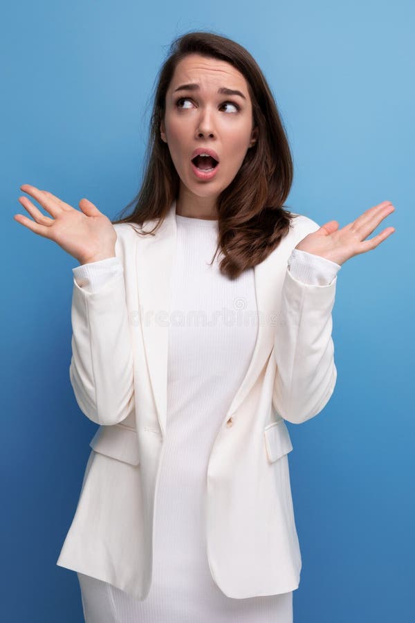 Surprised Confused Pretty Brunette Young Woman in a Dress and Jacket ... Surprised Confused Pretty Brunette Young Woman in a Dress and Jacket ...