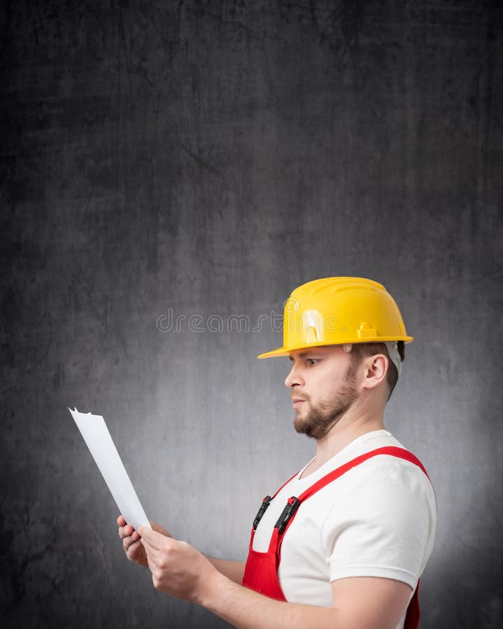 A Surprised Construction Worker Holding Papers or Documents Stock Image ...