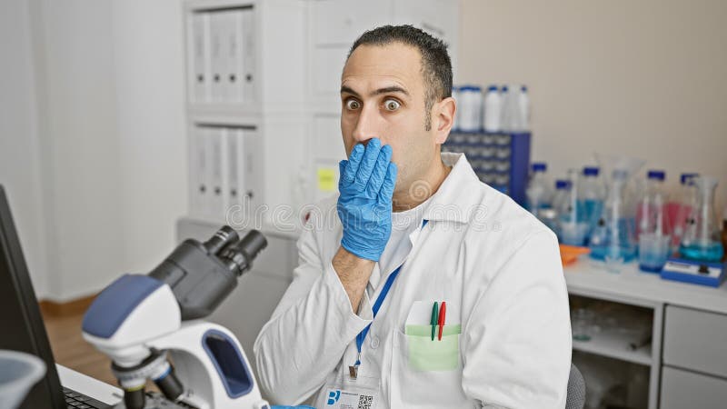 Surprised Hispanic Man in Lab Coat and Gloves Working in a Laboratory ...