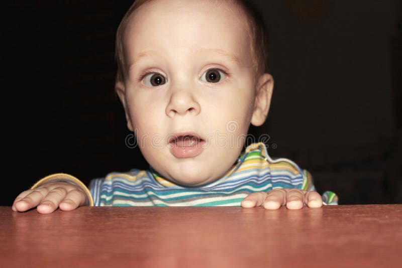 Surprised Little Boy Peeking from a Table Stock Image - Image of ...