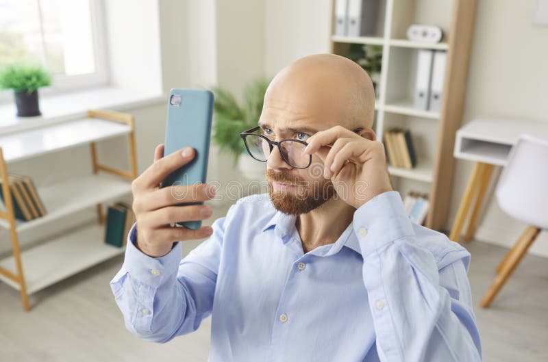 Surprised Man Browsing News on Smartphone while Working in Office Stock ...