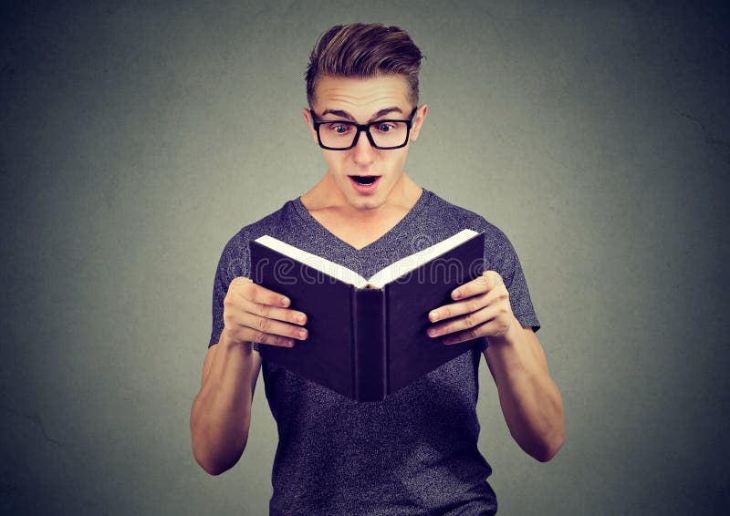 Man Reading Interesting Book with Shocked Face Expression Stock Photo ...
