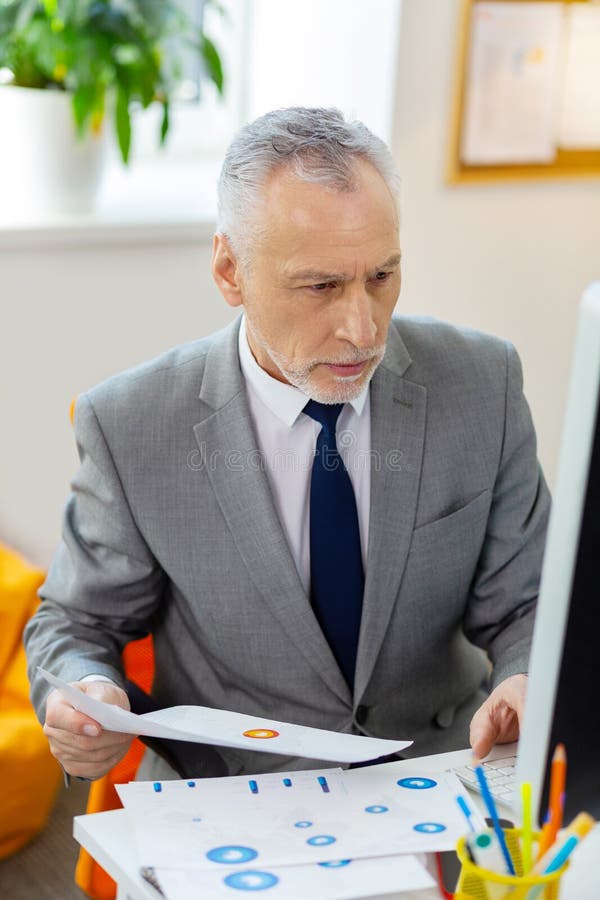 Surprised Man with Grey Stubble Comparing Data on the Screen Stock ...