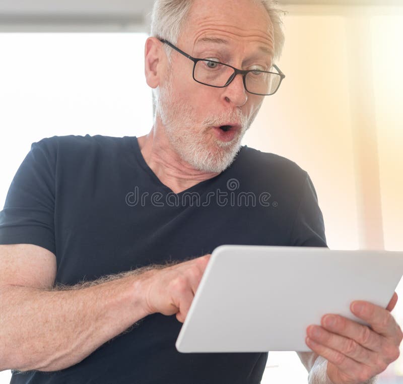 Surprised Man Looking at His Digital Tablet, Light Effect Stock Photo ...