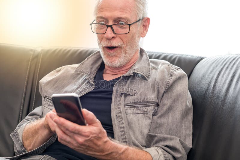 Surprised Man Looking At His Mobil Phone Light Effect Stock Image