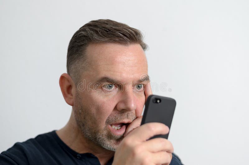 Surprised Man Looking at His Mobile Phone Stock Image - Image of ...
