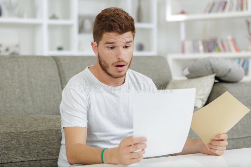 Surprised Man Looking at Paper Stock Image - Image of surprise ...