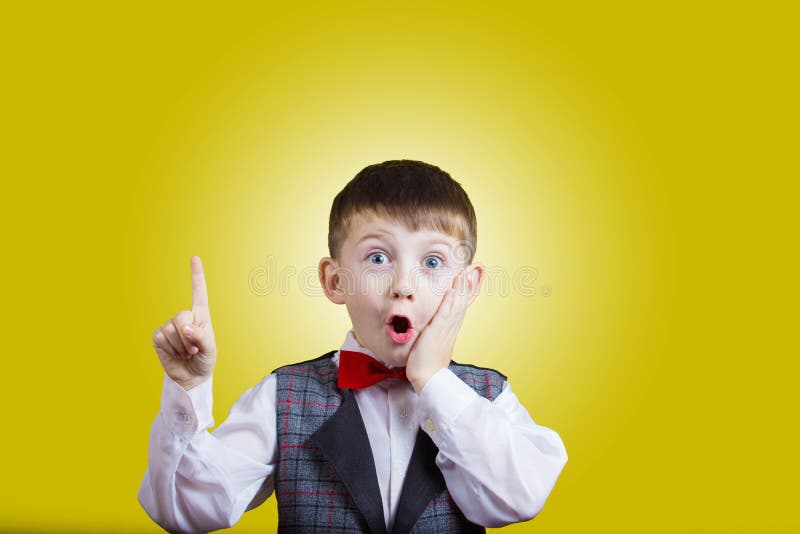 Surprised Pointing Little Boy Isolated Over Yellow Background. Stock ...