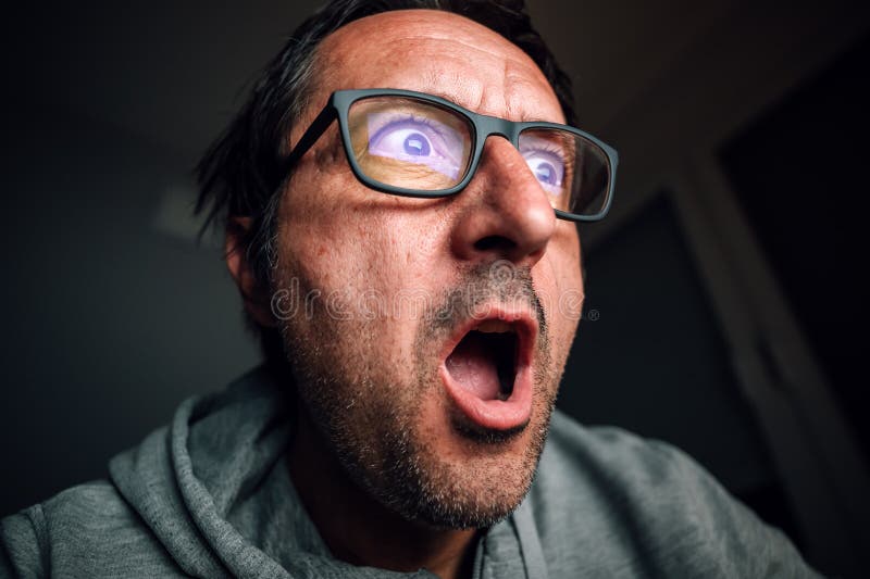 Surprised and Shocked Man Looking at Computer Screen while Browsing ...