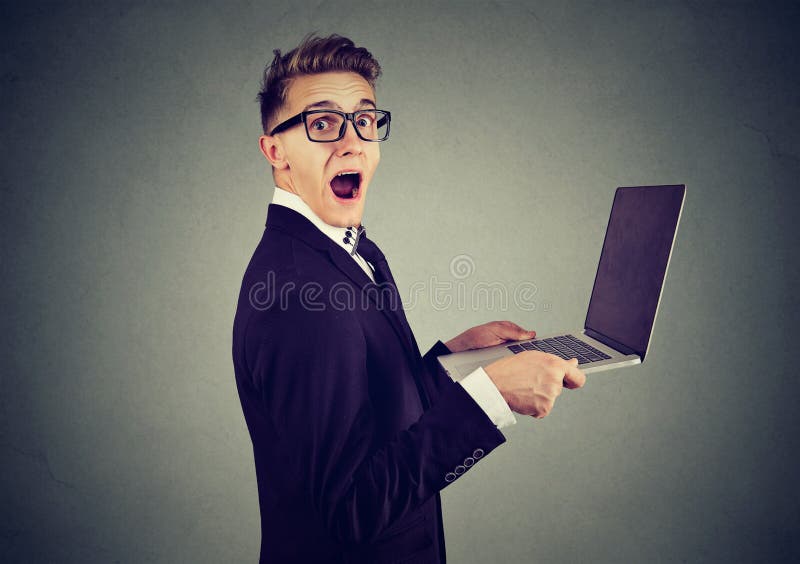 Surprised Stunned Man With Laptop Computer Looking At Camera Stock