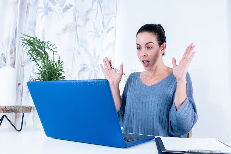 Surprised Woman Looking at a Laptop Screen Raising Her Hands in Shock ...