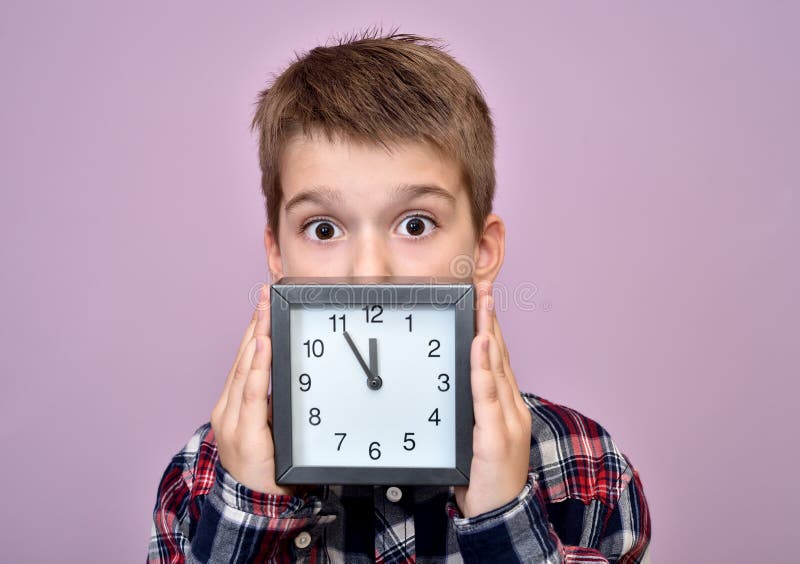 Surprised Young Boy with a Clock Stock Photo - Image of midnight, hour ...