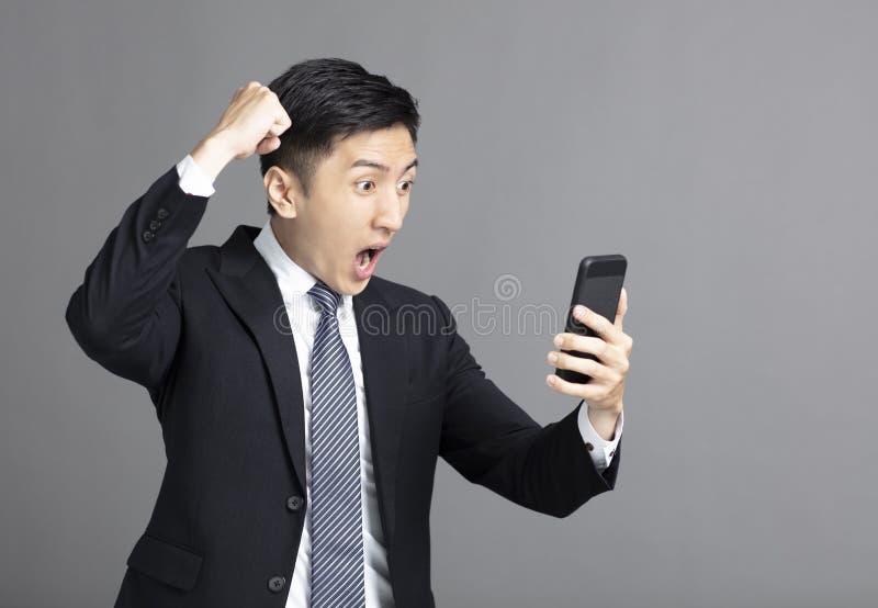 Surprised Young Business Man Watching the Mobile Phone Stock Photo ...