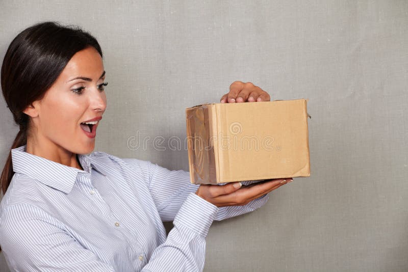 Surprised Young Lady Opening a Package Stock Image - Image of impressed ...