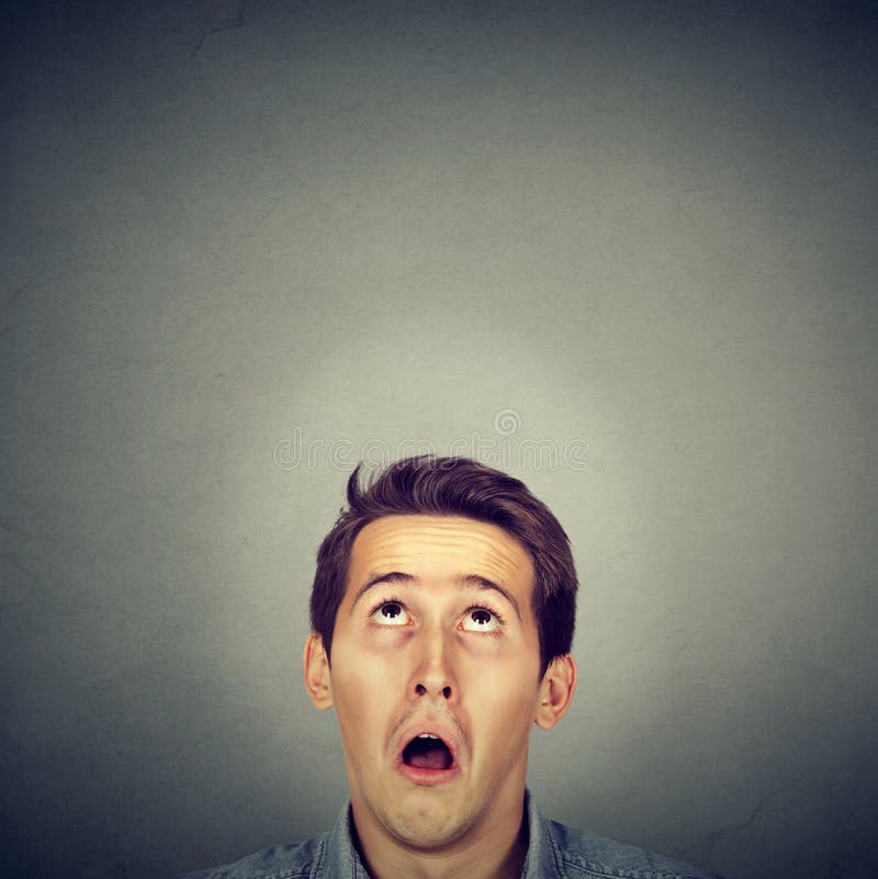 Surprised Young Man Looking Up Stock Image - Image of wondering ...