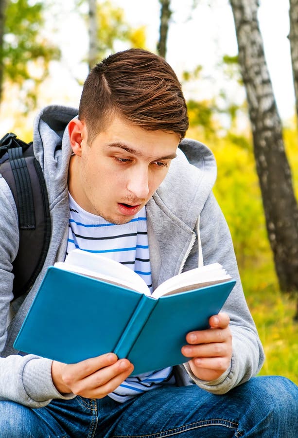 Surprised Young Man with a Book Stock Image - Image of worry, autumn ...