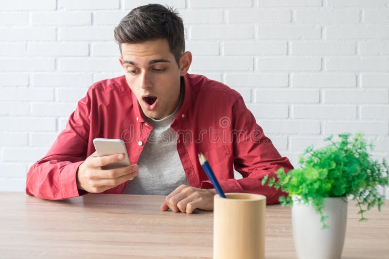 Surprised Young Man Watching Mobile Stock Photo - Image of lottery ...