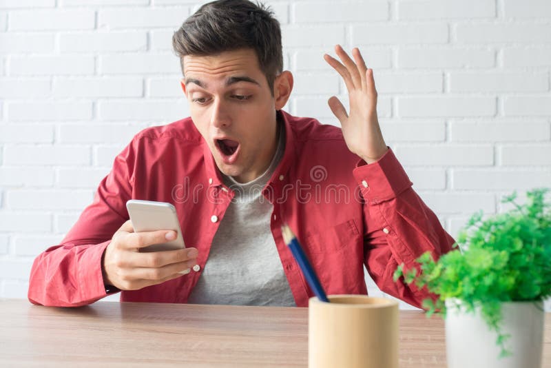 Surprised Young Man Watching Mobile Stock Image - Image of giveaway ...