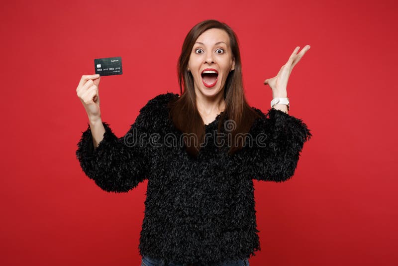 Surprised Young Woman In Black Fur Sweater Keeping Mouth Wide Open