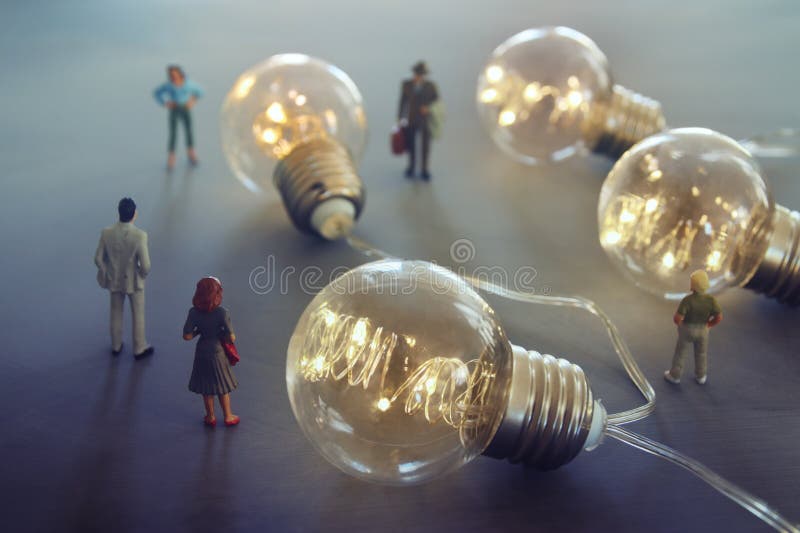 Surreal Image of People Looking at Glowing Light Bulbs. Concept of ...