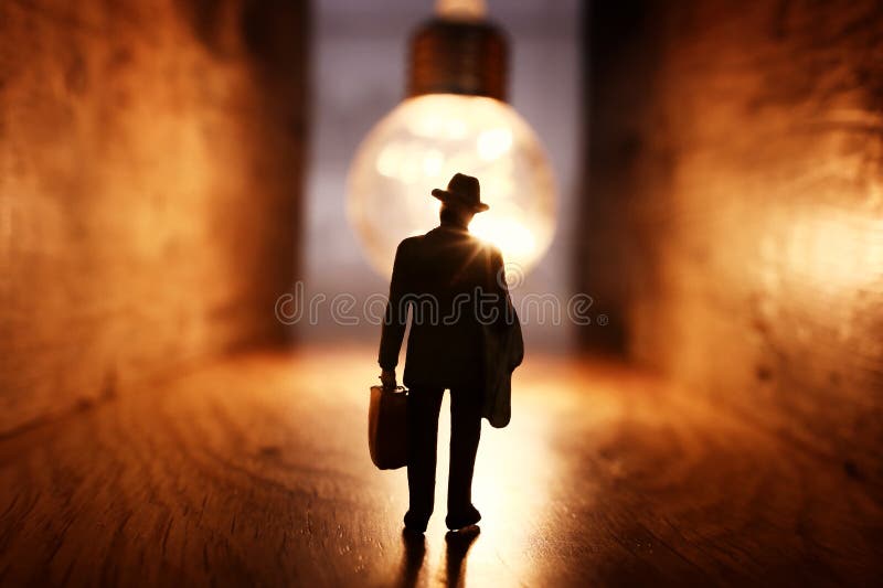 Surreal Image of Person in Dark Corridor Looking at Glowing Light Bulb ...