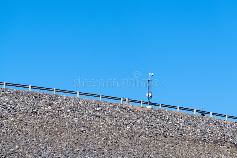 A Surveillance Camera by a Guardrail on an Upward Sloping Highway Stock ...