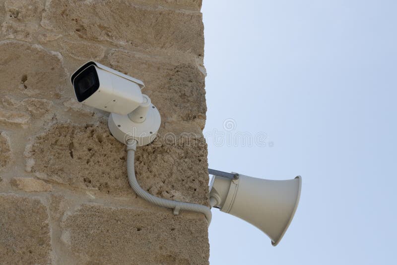 Surveillance Camera and Loudspeaker on Stone Wall Stock Image - Image ...