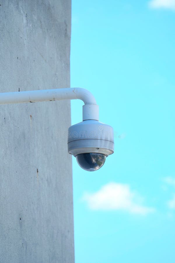 A Surveillance Camera is Mounted Securely on a Solid Concrete Wall ...