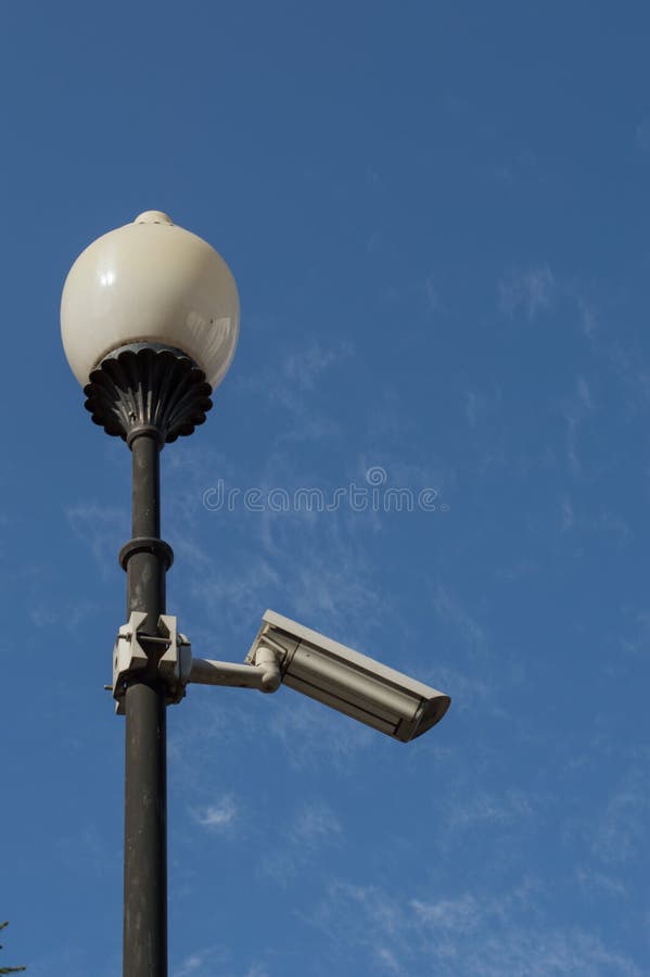 Surveillance Camera on a Pole with a Lantern, Against Blue Sky Stock ...