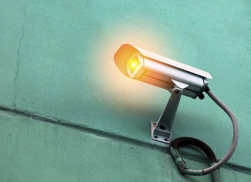 Surveillance Camera with Warning Light Mounted on Green Wall Stock ...