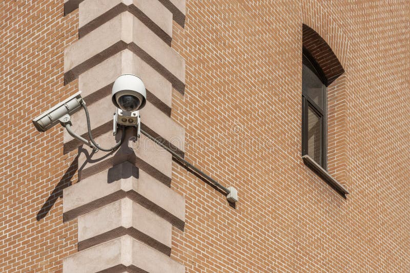 Surveillance Cameras Attached To a Corner of a Building Covering ...