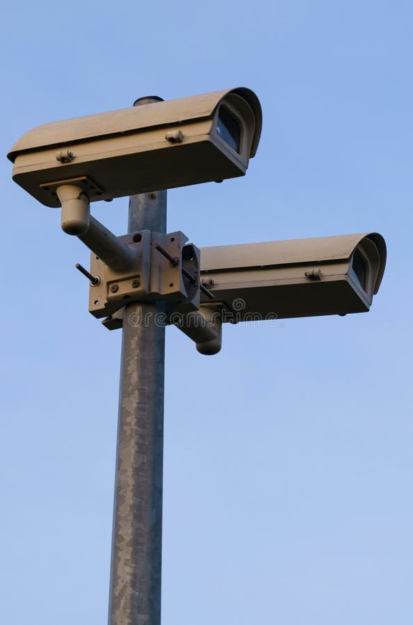 Surveillance Cameras Mounted on a Pole Against the Blue Sky. Stock ...