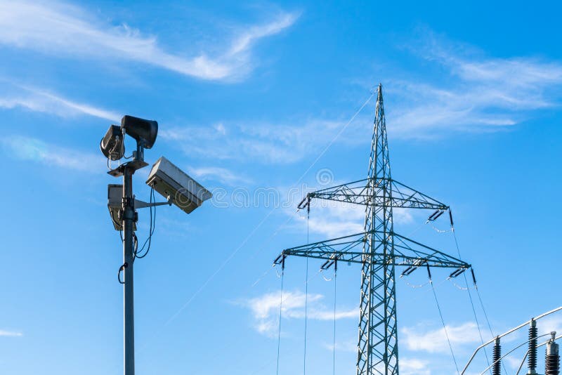 Surveillance Cameras on a Pole and a High-voltage Line Mast. Stock ...