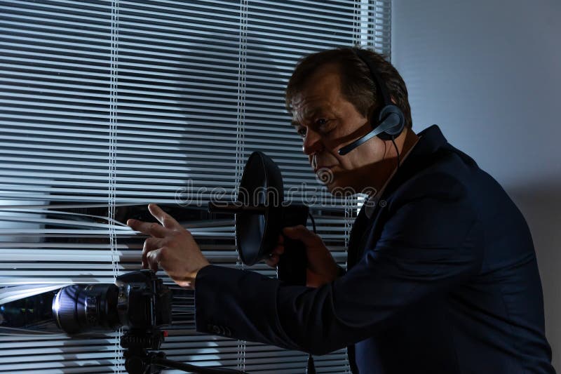 Surveillance Scene with Professional Equipment: Camera, Laptop ...