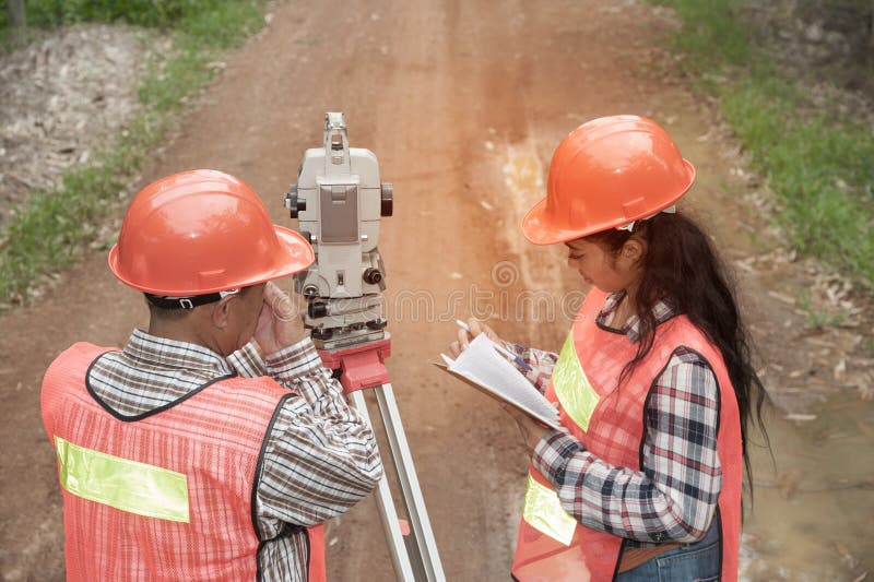 Surveyor or Engineer Making Measure by Theodolite in a Field. Stock ... Surveyor or Engineer Making Measure by Theodolite in a Field. Stock ...