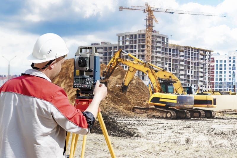 Construction of a Residential Area. Geodetic Stakeout. Surveyor at a ...