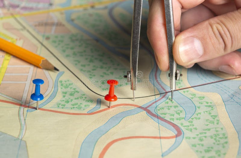 The Surveyor Marks the Distance on the Map with Red Buttons. Close-up ...