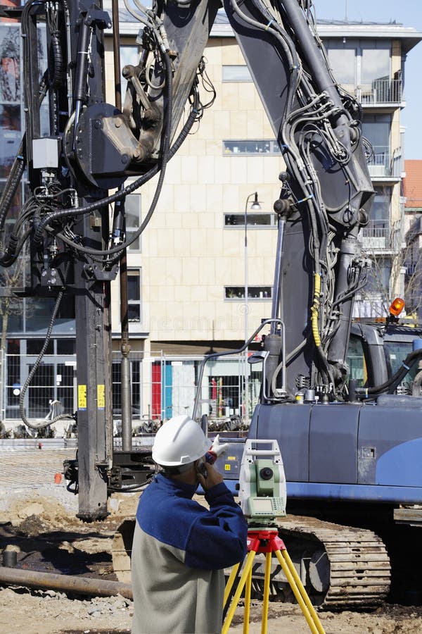 Surveyor Measuring Inside Large Building Site Stock Photo - Image of ...